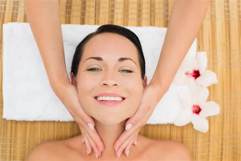 Smiling Brunette Enjoying A Facial Massage Stock Image Everypixel
