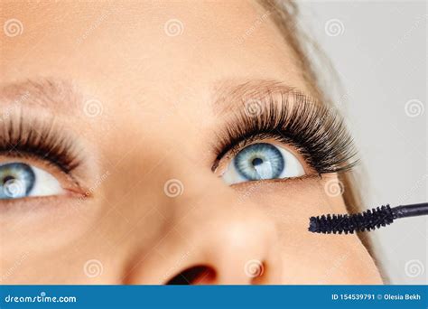 Female Eyes With Long Eyelashes And Brush Of Mascara Make Up And