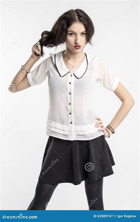 Slender Brunette Girl Removes A Business Suit Undressing Stock Image