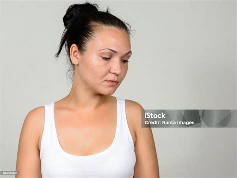 Young Beautiful Woman Wearing White Tank Top Against White Background