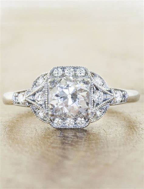 An Old Fashioned Diamond Ring Sits On A Table