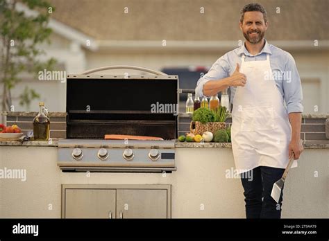 Man Grilling Salmon Fillet For Barbecue Thumb Up Man Grilling Salmon