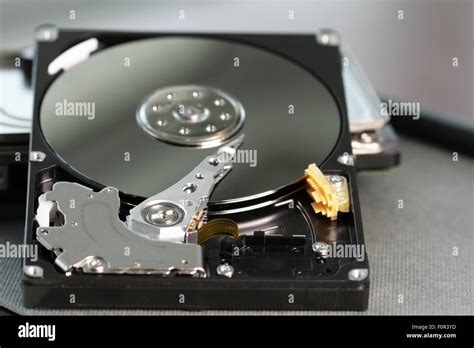 Close Up Of Open Computer Hard Disk Drive On Desk And Notebook Stock Photo Alamy