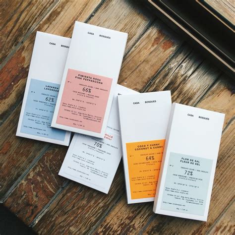 Three Menus Sitting Next To Each Other On Top Of A Wooden Table