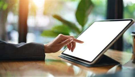 Hands Interact With Tablet On Clean White Desk Symbolizing Modern Office Technology Use