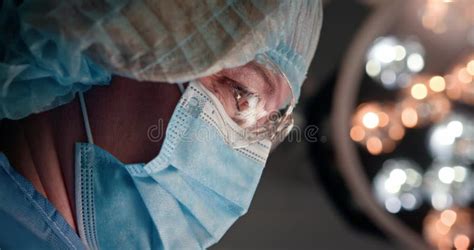 Focused Surgeon In Operating Room During A Complex Medical Procedure