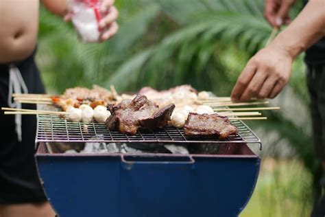 Premium Photo Person Preparing Food On Barbecue Grill