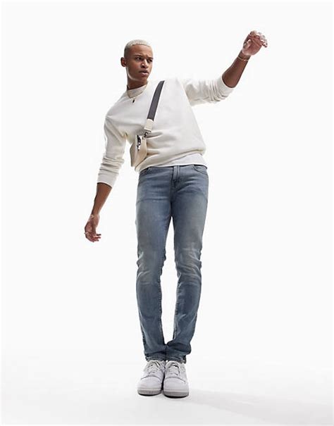 Asos Design Skinny Jeans In Mid Wash Blue Asos