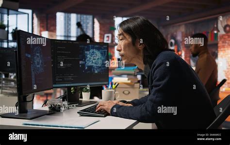 Software Engineer In Small Business Workspace Using Computer To Oversee Artificial Intelligence