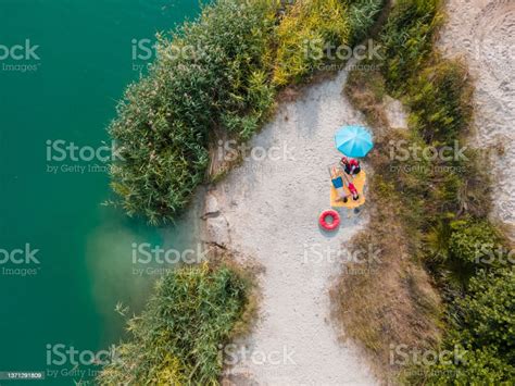 Couple Laying On Blanket Sunbathing At Sandy Beach Blue Azure Water