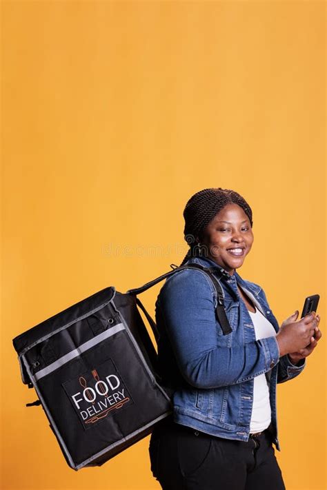 Restaurant Delivery Employee Holding Smartphone Looking At Customer