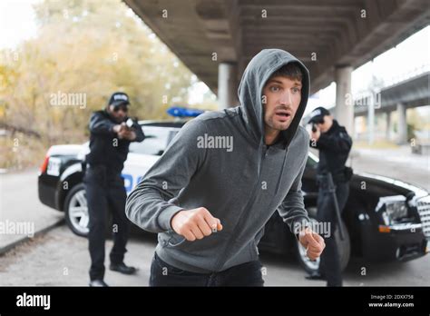 Scared Hooded Offender Running From Multicultural Police Officers
