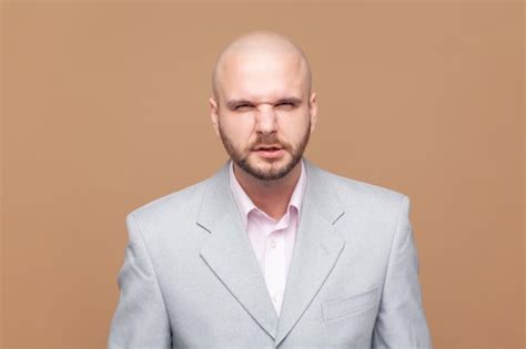 Premium Photo Man Looks Grumpy Feels Offended And Displease Clenched