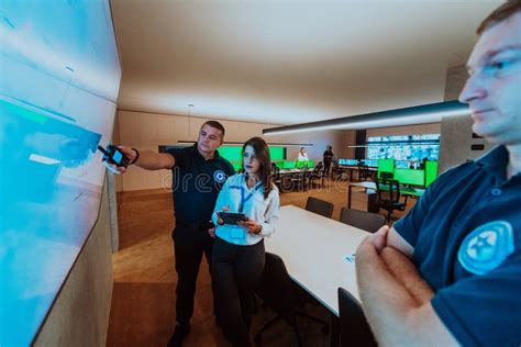 Group Of Security Operators Working In A Data System Control Room Technical Operators Working At