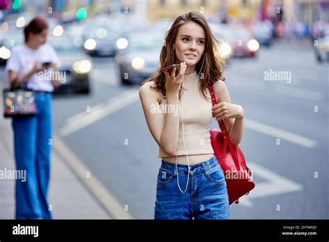 Woman Uses Virtual Voice Assistant Function On Her Smartphone Outdoors