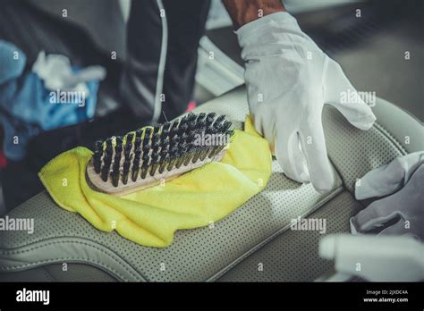 Vehicle Cleaner In White Gloves Precisely Cleaning Car Leather Seats