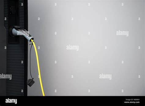 A Charging Cable For An Electric Vehicle Is Connected At A Charging