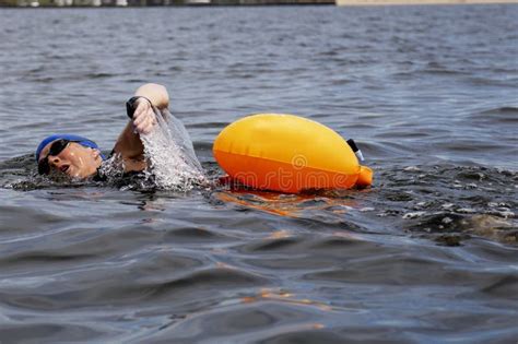 Close Up Of A Women Swimming Wearing An Orange Floatation Safety Device Stock Image Image Of