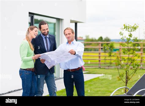 Architect Showing Man And Woman Real Estate Blueprint For Home Building Stock Photo Alamy