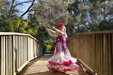 A Girl Dancing Flamenco Playing With Soap Bubbles In Typical Flamenco