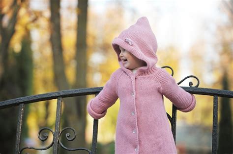 Premium Photo Cute Girl Looking Away While Standing Against Railing