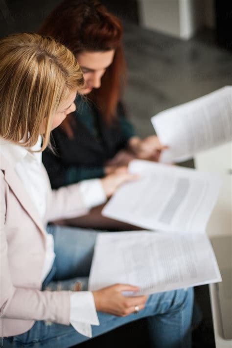 Analyzing Papers Together By Stocksy Contributor Nemanja Jovanovic Stocksy