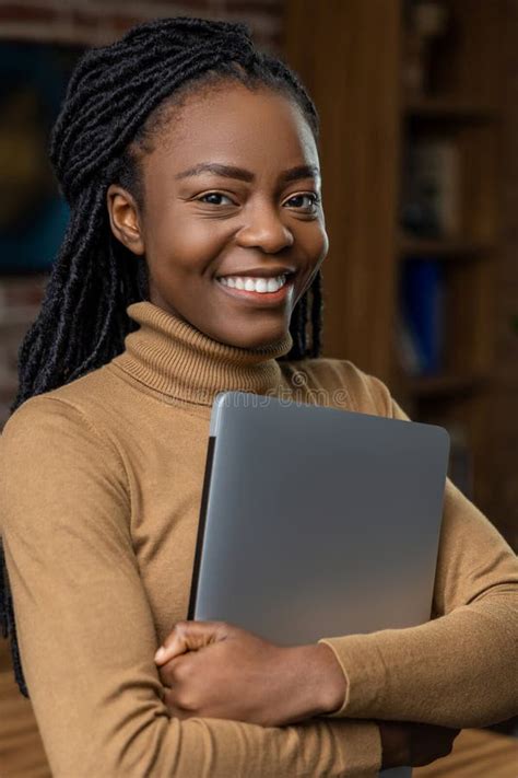 Confident Woman Embracing Closed Laptop Enjoying Remote Work In Home
