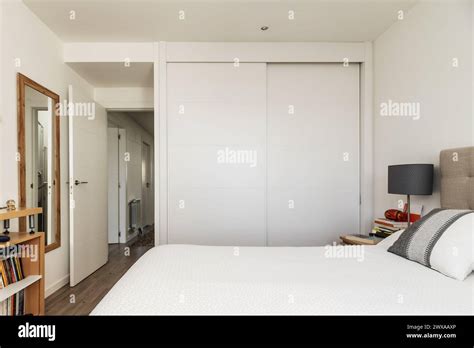 Bedroom With Double Bed With White Bedspread Light Wooden Floors