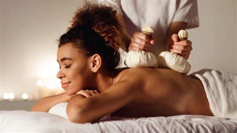 Premium Photo Woman Receiving Herbal Compress Massage At Spa