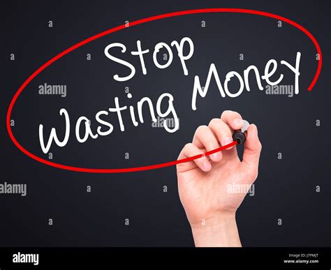 Man Hand Writing Stop Wasting Money With Black Marker On Visual Screen