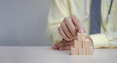 Premium Photo Hand Doctor Holding Wood Cube BlockBusiness Growth