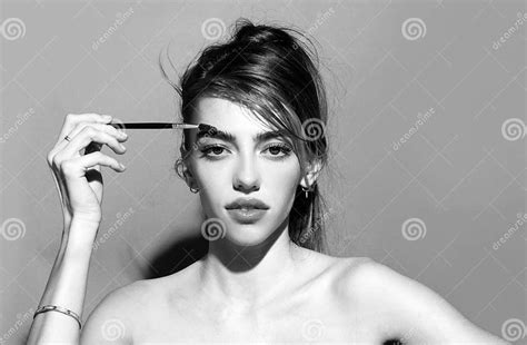 Combs Eyebrows With A Brush In A Beauty Salon Woman With Long