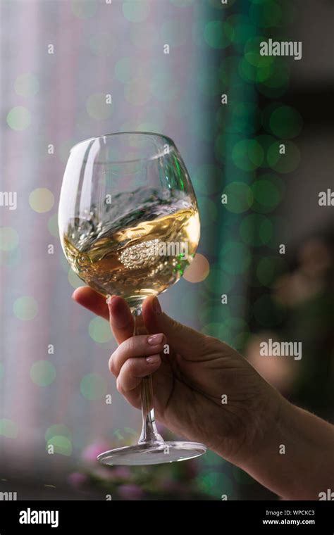 Hand Sommelier Holding Glass Of White Wine Swirling Wine Glass In Wine
