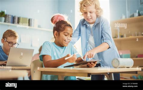 Elementary School Computer Science Class Smart Girl Uses Digital Tablet Computer Her Classmate