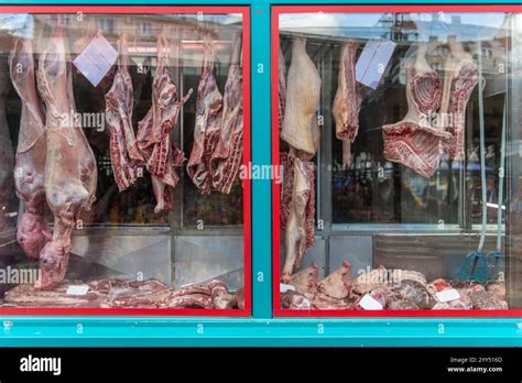 Fresh Hanging Meat Carcass On A Stylish Butcher Shop Window And Its