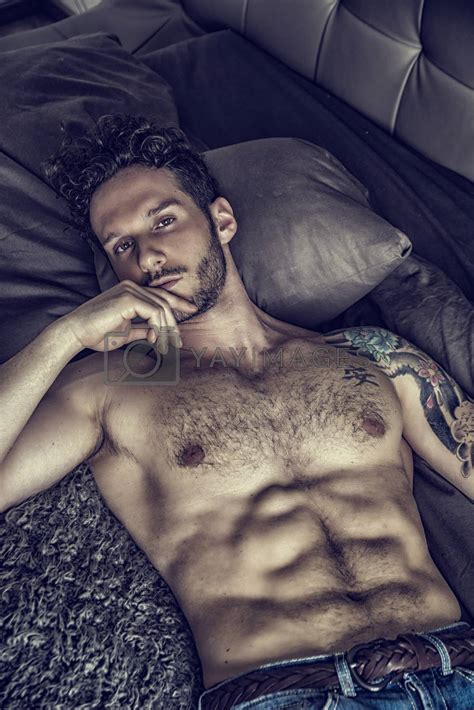 Shirtless Sexy Male Model Lying Alone On His Bed By Artofphoto Vectors
