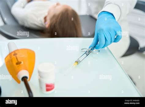 Pedodontist Preparing To Give Local Anesthetic Injection To Girl Stock
