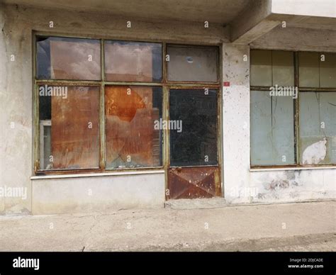 The Remaining Of A Shop With Rusty Windows And Broken Windows Stock