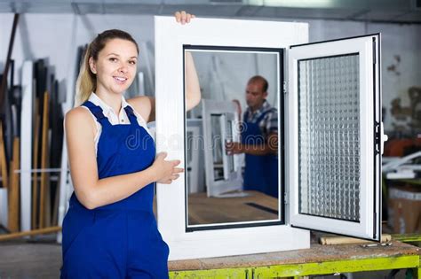 Confident Girl Assembler Of Plastic Windows Standing With Arms Crossed