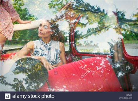 Young Woman Daydreaming In Car
