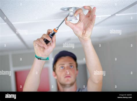 Man Replacing Spotlight Bulb Stock Photo Alamy