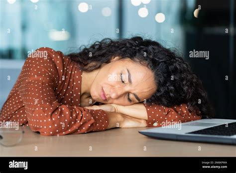 Beautiful Tired Hispanic Woman Sleeping On Desk Close Up Business