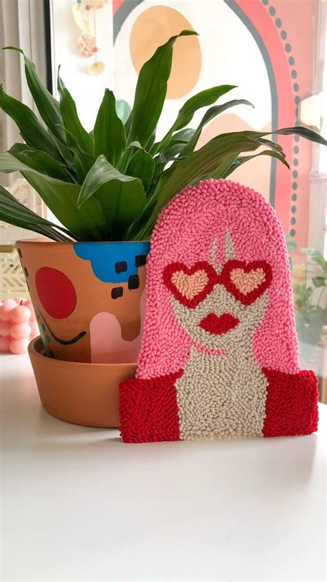 A Potted Plant Sitting On Top Of A Table Next To A Towel Shaped Like A