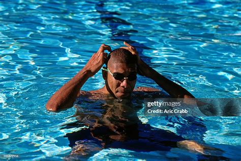 Tim Duncan Of The San Antonio Spurs Swims In A Pool During An Episode