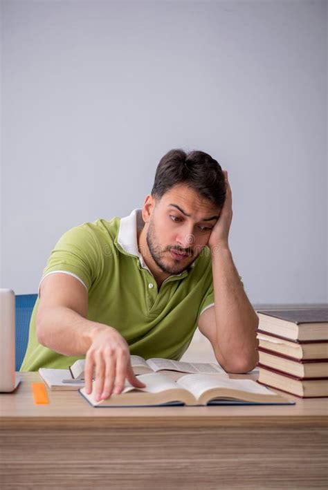 Young Male Student Sitting In Front Of Whiteboard Stock Image Image