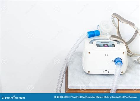 Cpap Machine With Air Hose And Head Mask On Bedside Table Stock Image