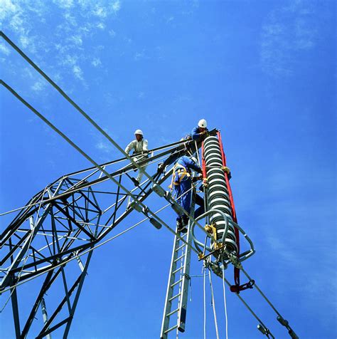 Technicians Servicing A Power Line In Training Photograph By Chris Knapton Science Photo Library