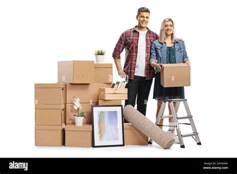 Young Couple Posing With Removal Boxes Isolated On White Background