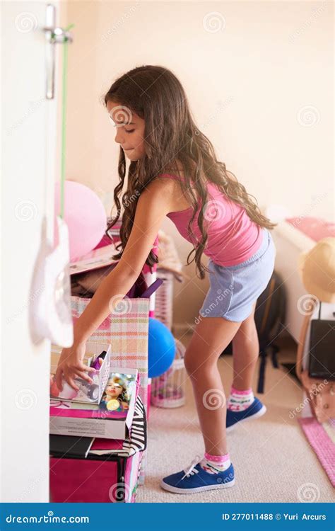 Making Sure Everything Is Neat And Tidy A Young Girl Tidying Up Her