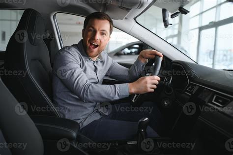 Visiting Car Dealership Handsome Bearded Man Is Stroking His New Car
